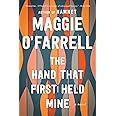 Amazon.com: The Hand That First Held Mine: A Novel: 9780547423180: O ...